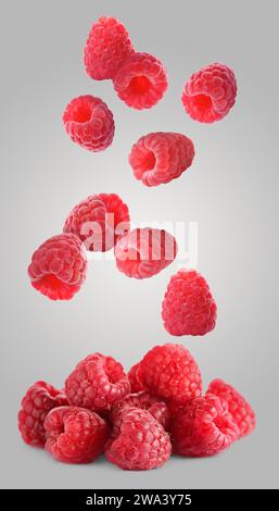 Fresh ripe raspberries falling onto pile against white background Stock ...