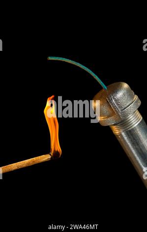 A metal pipe bomb with lit match against a black background Stock Photo ...