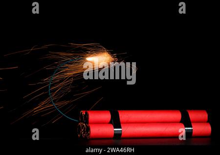 A bundle of dynamite with lit fuse again black background Stock Photo ...