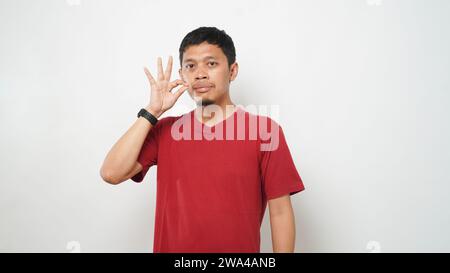 Asian man is using sign language with hand against white background ...