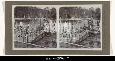 Bridge construction, working with caissons. Lowering or digging ...