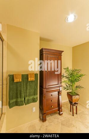 Remodeled bathroom in a middle-class home. A piece of wooden furniture ...