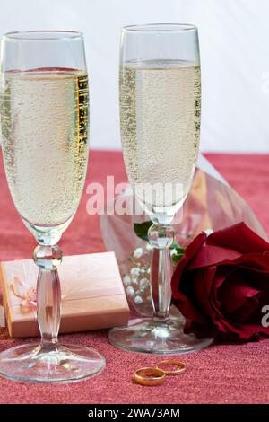 Valentines day card with champagne, rose flowers and gift box. On red ...