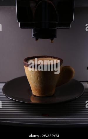 Coffee machine with delicious edible biscuit cup Stock Photo - Alamy
