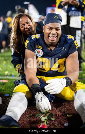 Michigan defensive lineman Kris Jenkins, right, returns an interception ...