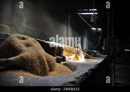 Bangladeshi worker works in a puffed rice factory in Dhaka City in ...
