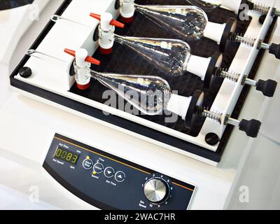 Laboratory reciprocating mixer shaker with flasks Stock Photo - Alamy