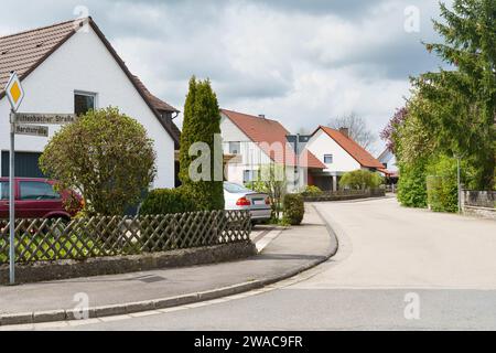 Weinberg, Germany - May 6, 2023: Houses along the road, cars in a ...