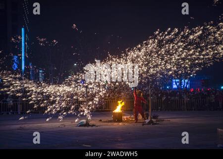 A traditional iron spraying known as Datiehua is staged in Yuyao City ...