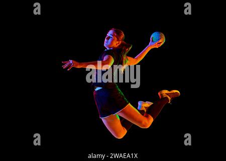 Fit, young, competitive female handball player demonstrating throwing ...