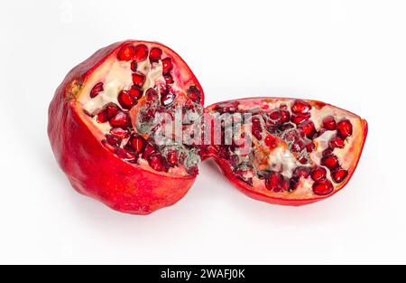 Spoiled red pomegranate with mold. Cut into pieces. White background ...
