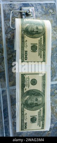 Roll of money bank notes toilet paper in bathroom Stock Photo - Alamy