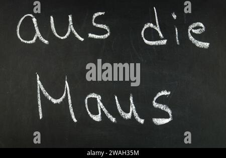 black board with the inscription 'Aus die Maus' at the end of a ...