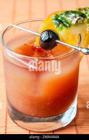 Bermuda Rum Swizzle cocktail garnished with fruits Stock Photo - Alamy