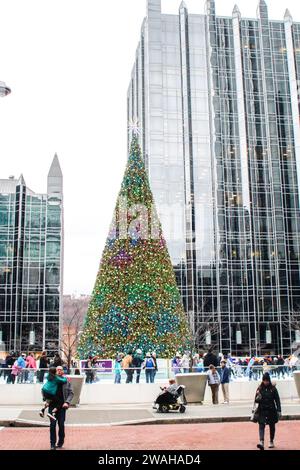 People gather along the outside of the PPG Arena Ice Rink to watch the ...