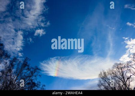 Stratus cloud with rare rainbow effect on blue sky Stock Photo - Alamy