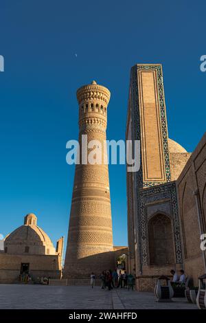 View over the Poi Kalon Madrassa through arch, at the twilight, Bukhara ...