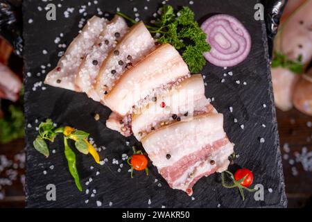 Smoked lard, bacon, half a piece, on a wooden dark craft background ...