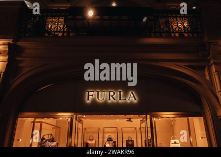 Famous brand Furla retail shop golden logo signboard on the storefront ...