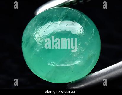 natural green emerald beryl gem on background Stock Photo - Alamy