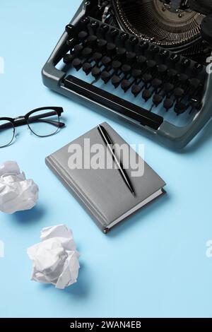 Vintage typewriter with notebook, eyeglasses and crumpled paper on ...