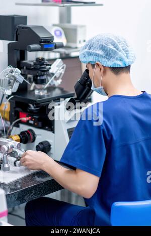 Doctor using IVF micromanipulator with Petri Dish on it for ...