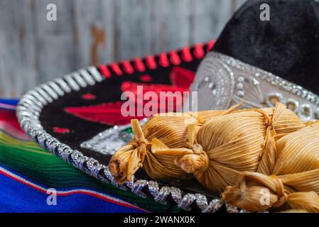 Tamales next to a serape and a Mexican mariachi hat Stock Photo - Alamy