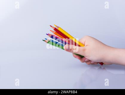 Hand holding color Pencils placed on a white background Stock Photo - Alamy