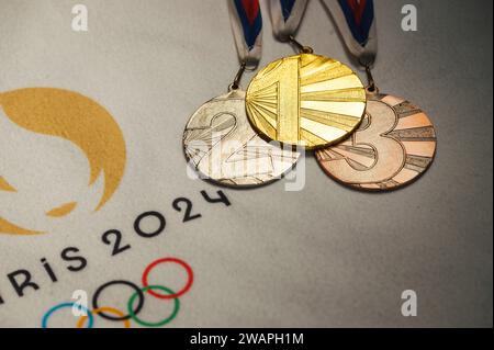 PARIS, FRANCE, JANUARY 4. 2024: Gold silver and bronze medal on white ...