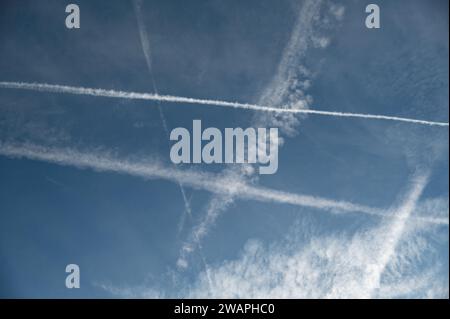 Contrails in clear winter sky Stock Photo - Alamy
