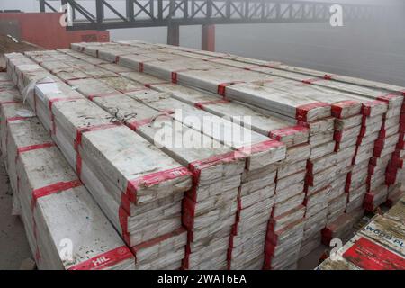Building materials are laid over a newly constructed pavement ahead of ...