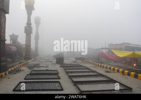 Road building materials like iron grills are seen over a newly ...