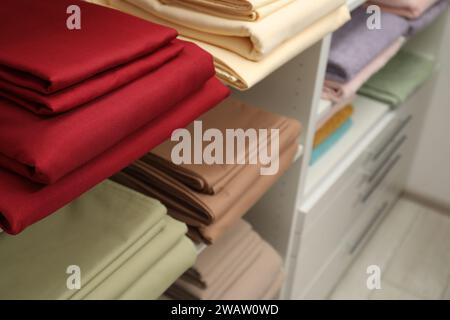 Different colorful bed linens on display in home textiles store Stock ...