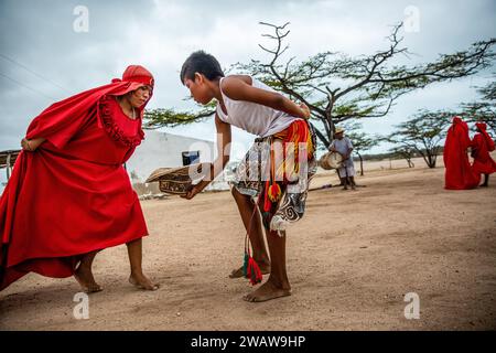 Wayuu indigenous boy in La Guajira, Colombia knitting a sash or strap ...