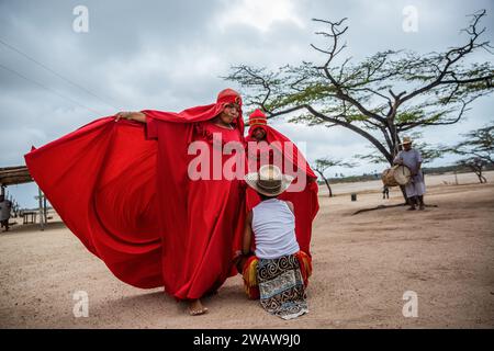 Wayuu indigenous boy in La Guajira, Colombia knitting a sash or strap ...