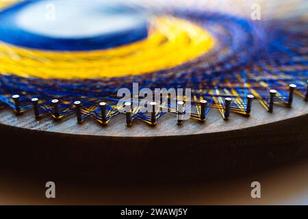 Colored thread mandala on a wooden board with nails. Mandala Moon ...