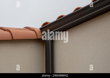 metal black aluminum gutter rain systems on home roof covered with ...