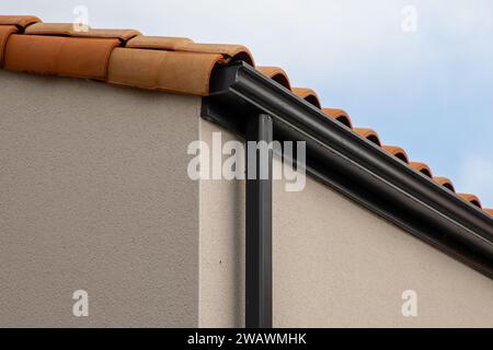 metal black aluminum gutter rain systems on home roof covered with ...