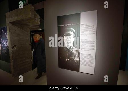 A woman walks through one of the rooms displaying World War II ...