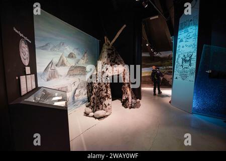 A person walks through one of the rooms displaying artifacts from the ...