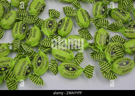 Bright, colorful factory menthol candies packed in green packaging with ...