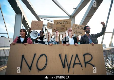 Multiracial diverse ages people protesting against war and violence in ...