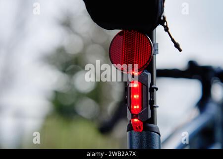 Glowing bicycle taillight. Red stop light for cyclist safety. Rear led ...