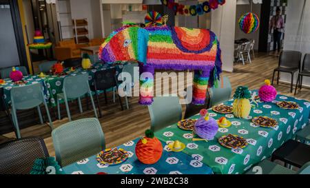 A colorful, traditional Mexican pinata shaped like an animal, resting ...