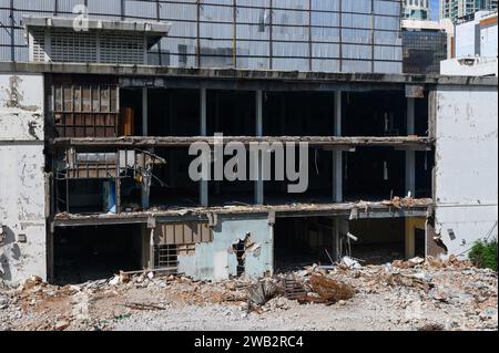 A large destroyed building with broken apartments and a pile of ...