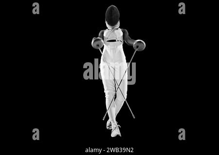 Artistry of combat. Female fencer gracefully executes complex fencing ...