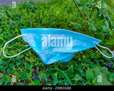 Dirty blue masks in nature. Corona virus pollution. Covid19. Corona ...