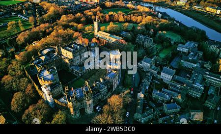 Aerial view of the Lancaster castle surrounded by greenery at sunset ...