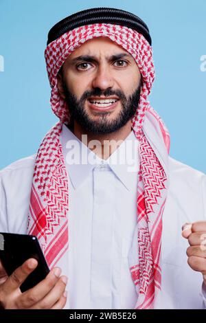 Excited saudi arab man holding stacks of money isolated on white ...