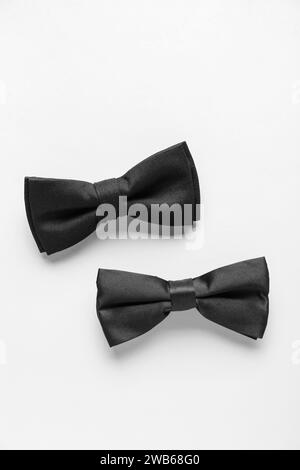Black bow ties on white background Stock Photo - Alamy